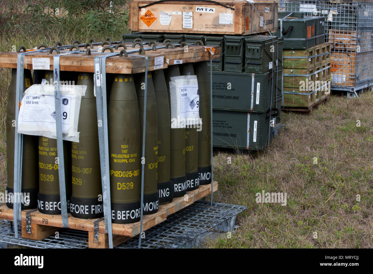 A pallet of 155 mm artillery shells and other munitions sit staged on ...
