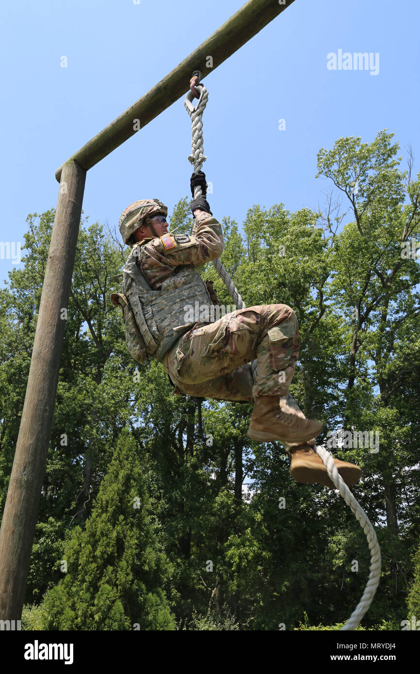 U.S. Army Cpl. Mark Combs, 52nd Ordnance Group (EOD), climbs a rope ...