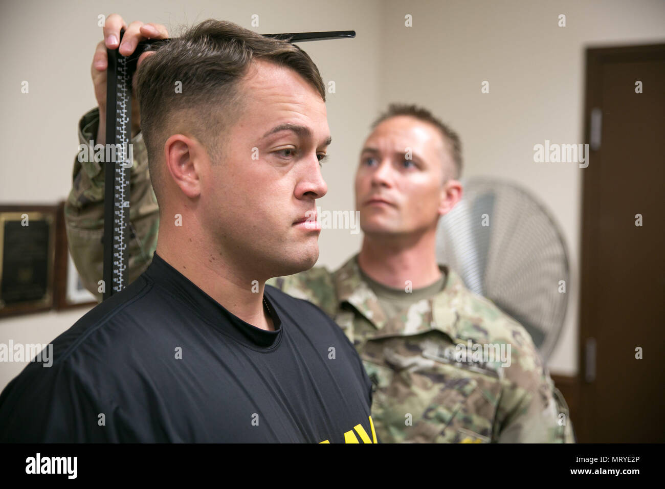 U.S. Army Sgt. 1st Class Joshua Weaver measures height and weight on ...