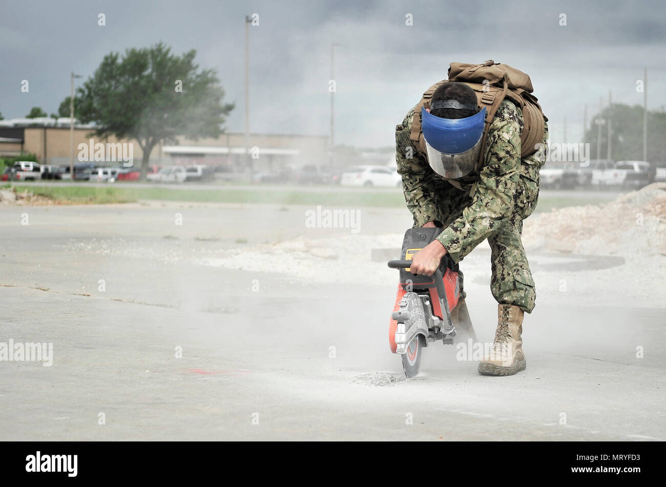 A Seabee assigned to Naval Mobile Construction Battalion (NMCB) 11 uses ...