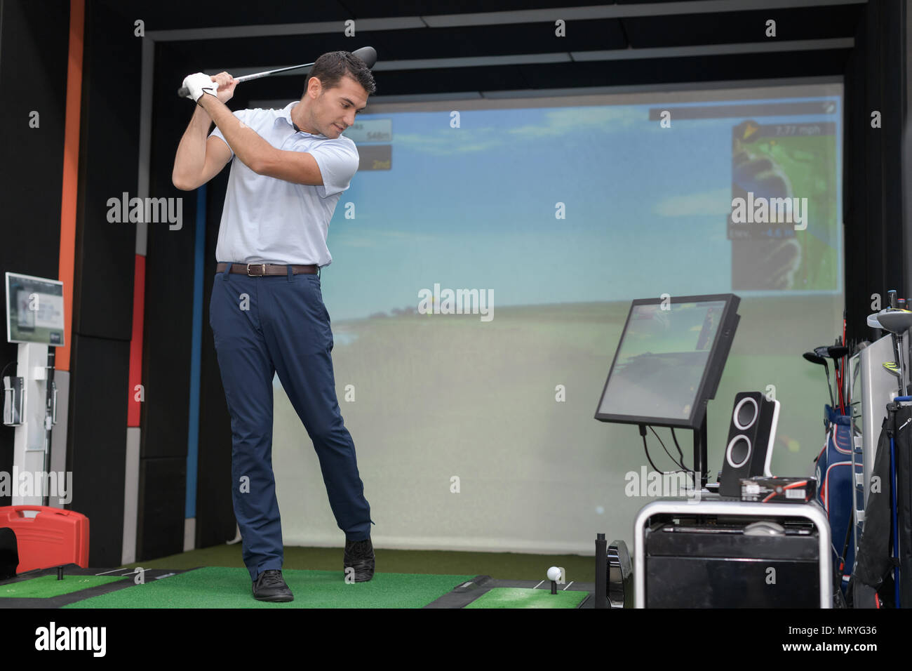 Man practicing golf swing using simulator Stock Photo - Alamy