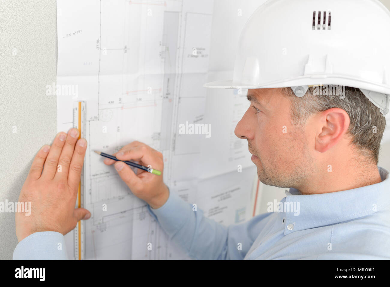 Architect drawing against a wall Stock Photo - Alamy