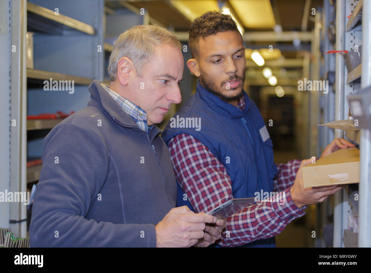 two workers workers in warehouse Stock Photo - Alamy