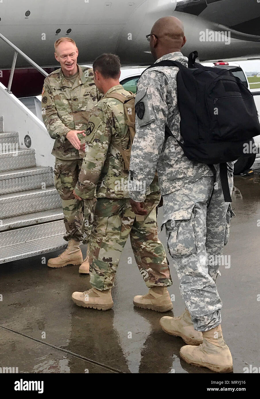 Col. Steven Barney, commander of the 230th Sustainment Brigade, shakes ...