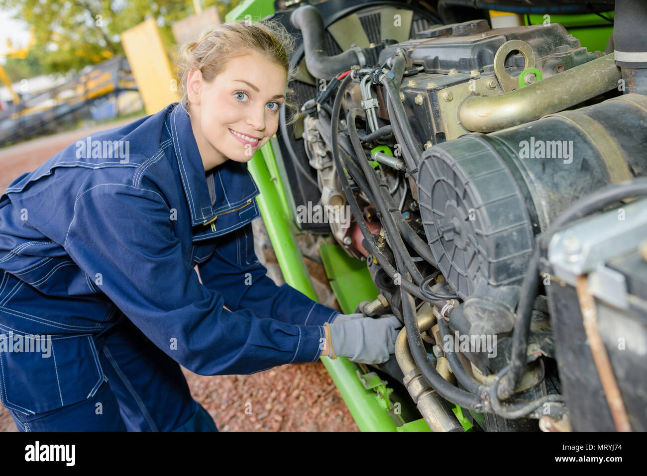 Lady adjusting engine component Stock Photo - Alamy
