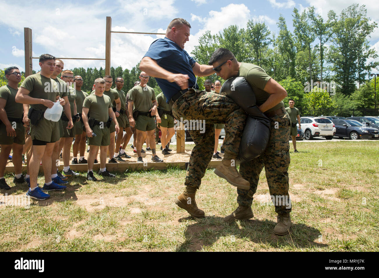 U.S. Marine Corps Gunnery Sgt. Kevin P. Cain knees a strike pad while ...