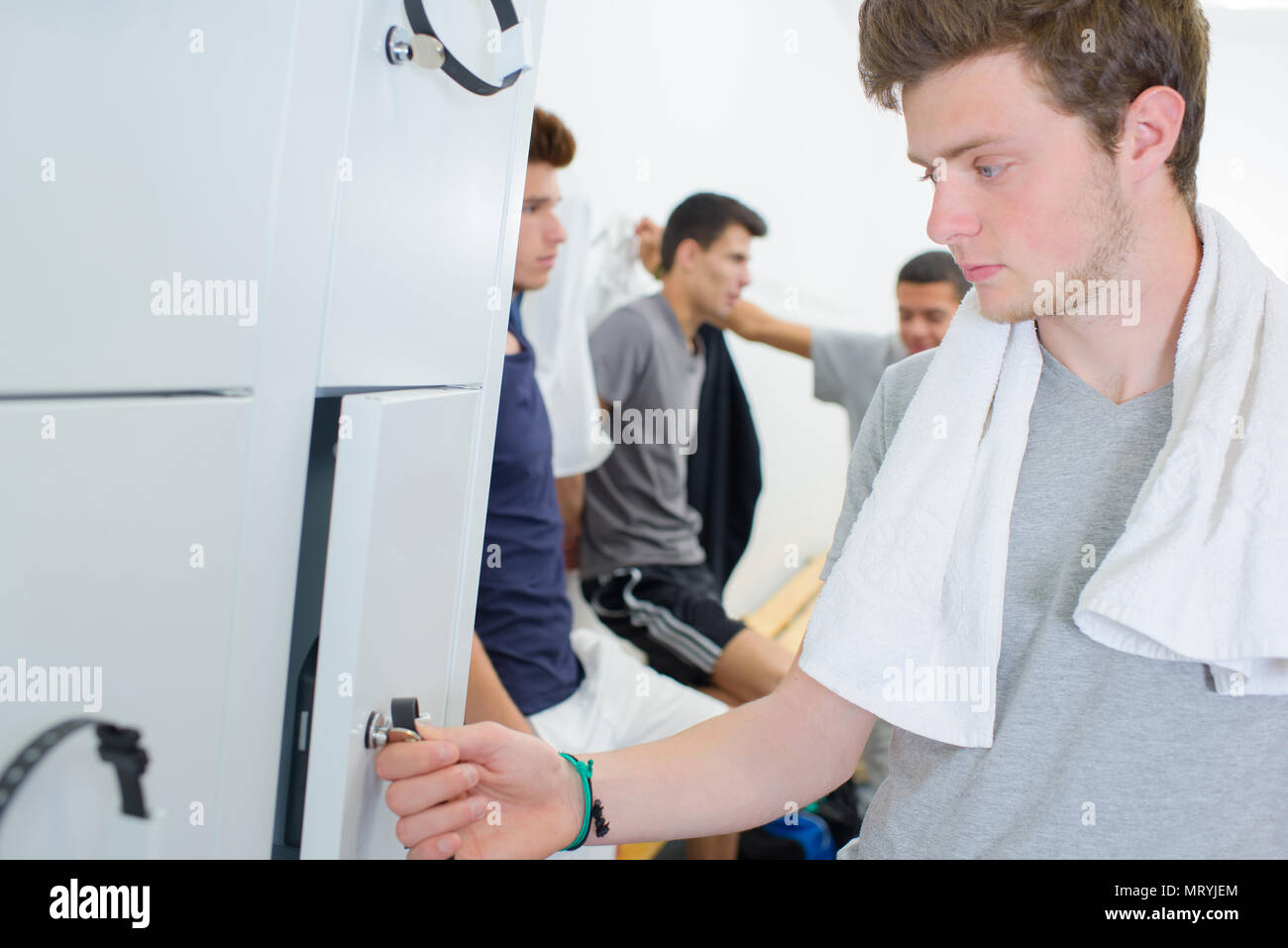 young man opening a locker Stock Photo - Alamy