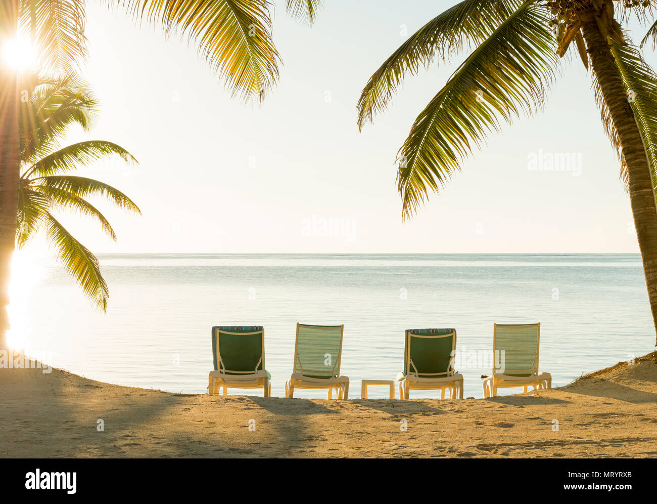 Beach holiday deckchairs in the sand overlooking the ocean Stock Photo ...