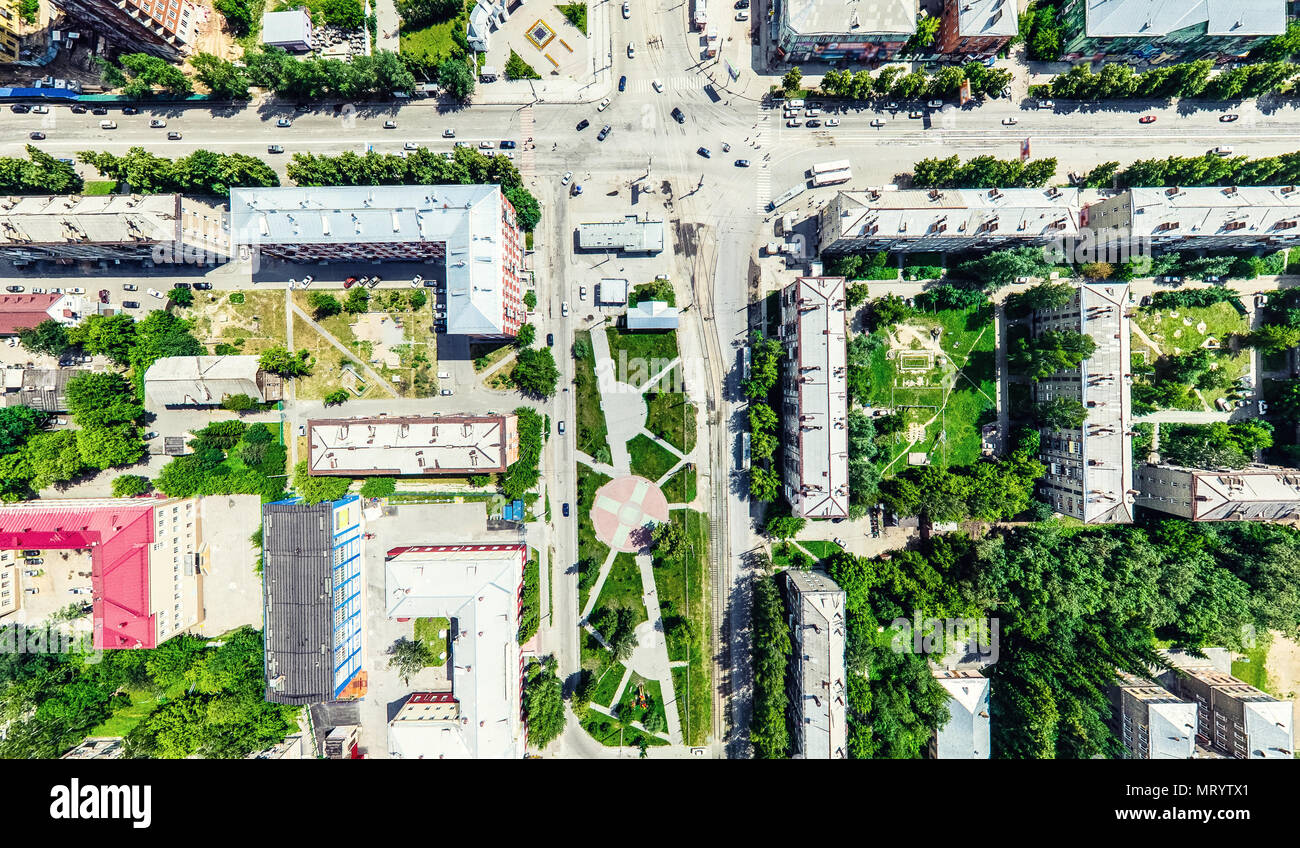 Aerial city view with crossroads and roads, houses, buildings, parks ...