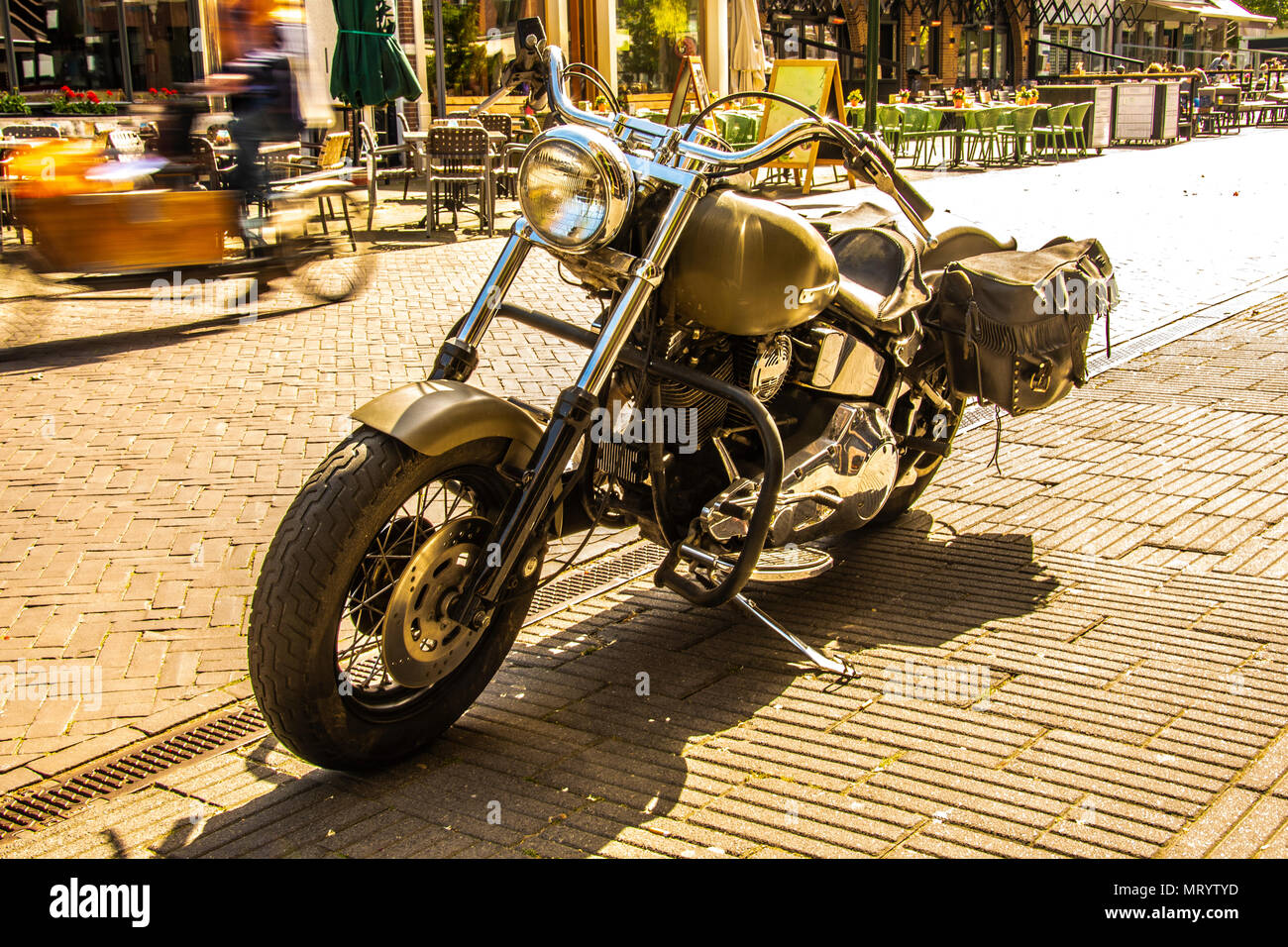 old and powerful vintage motorcycle with backpacks on a street in the ...