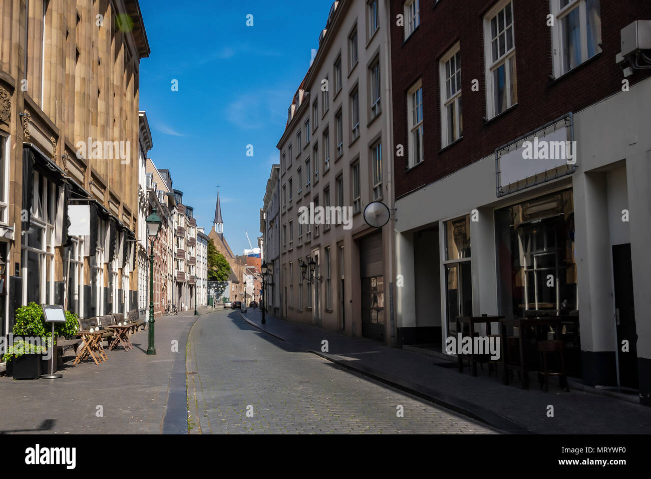 Typical street of the city of Breda in the background you see a church ...