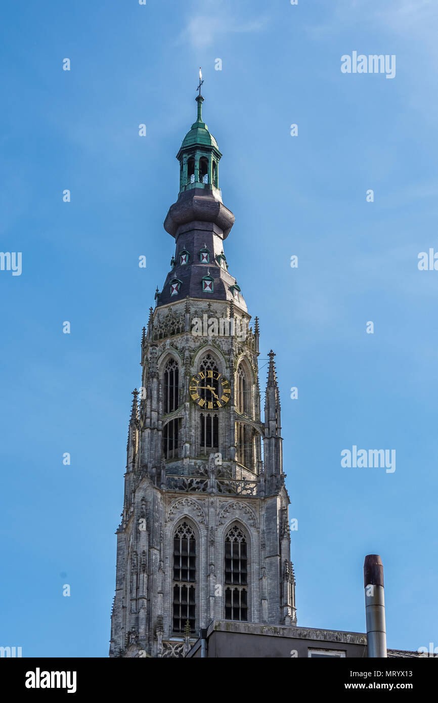 detail tower of the old great church of breda with its colorful clock ...