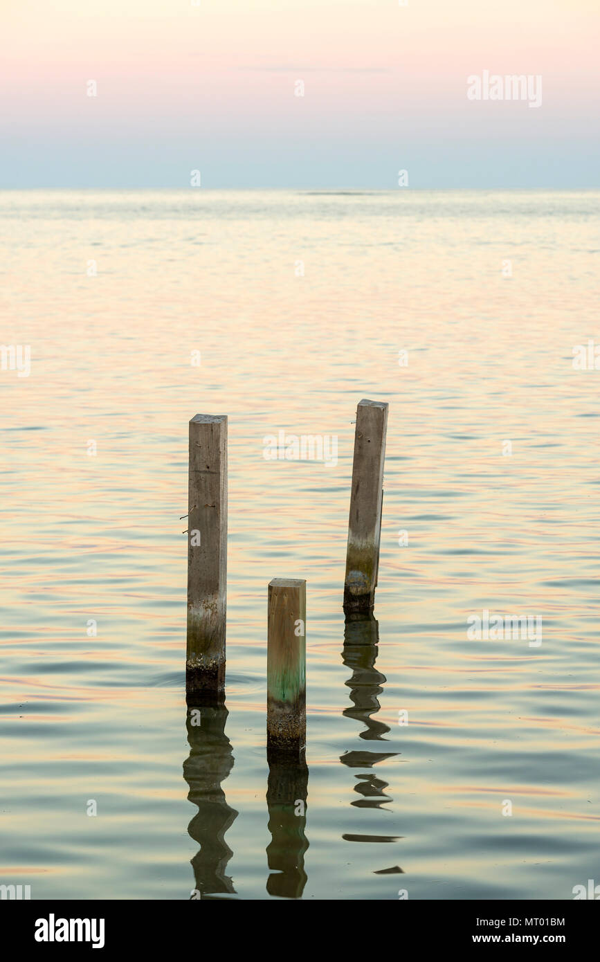 Ocean landscape with minimalism design of wooden pylons Stock Photo - Alamy