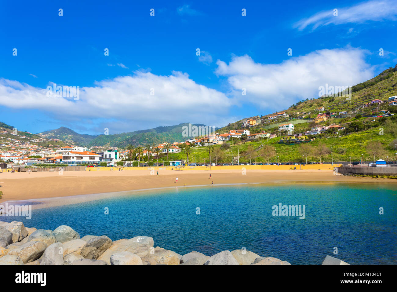 The famous beach of Machico in the summer holiday, with the blue water ...
