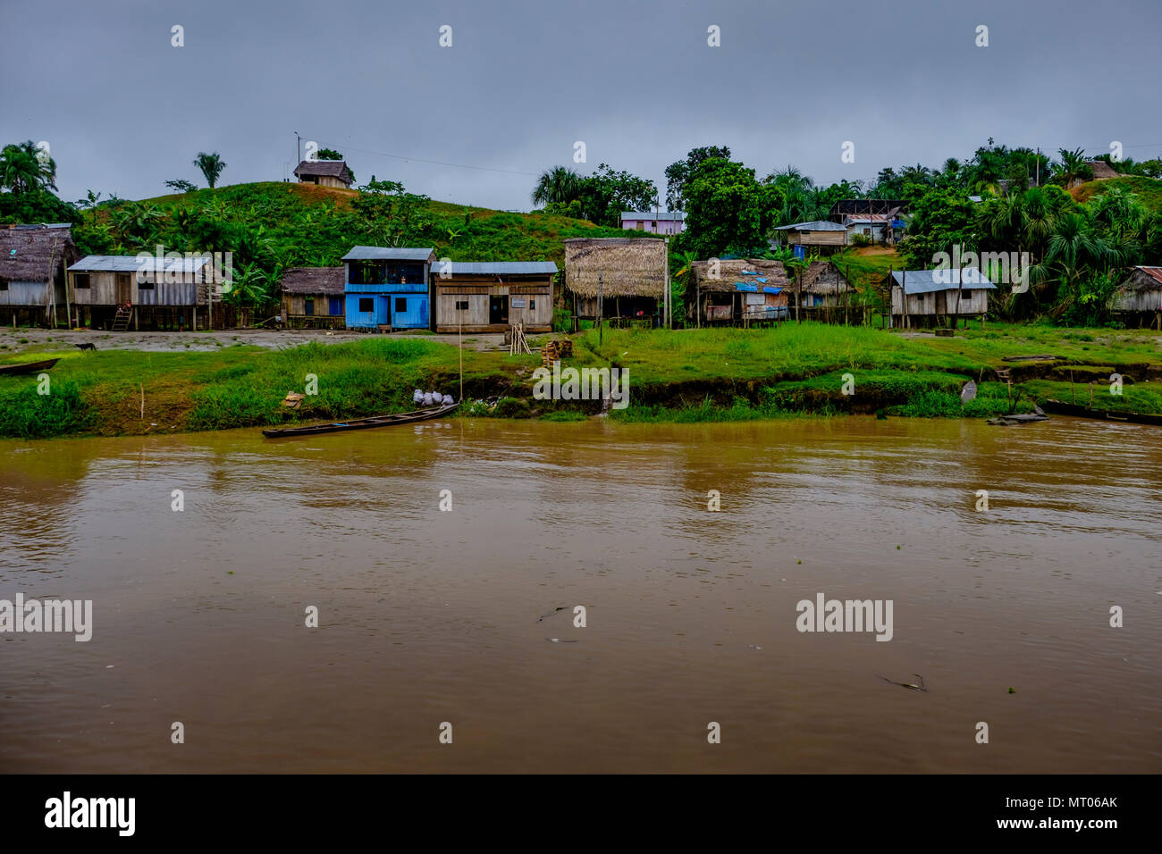 Remote village with typical wooden shack housing on the banks of the ...
