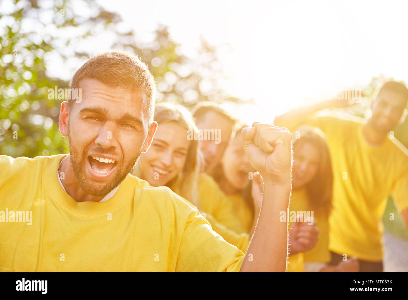 Teambuilding with cheering team or group in nature Stock Photo - Alamy