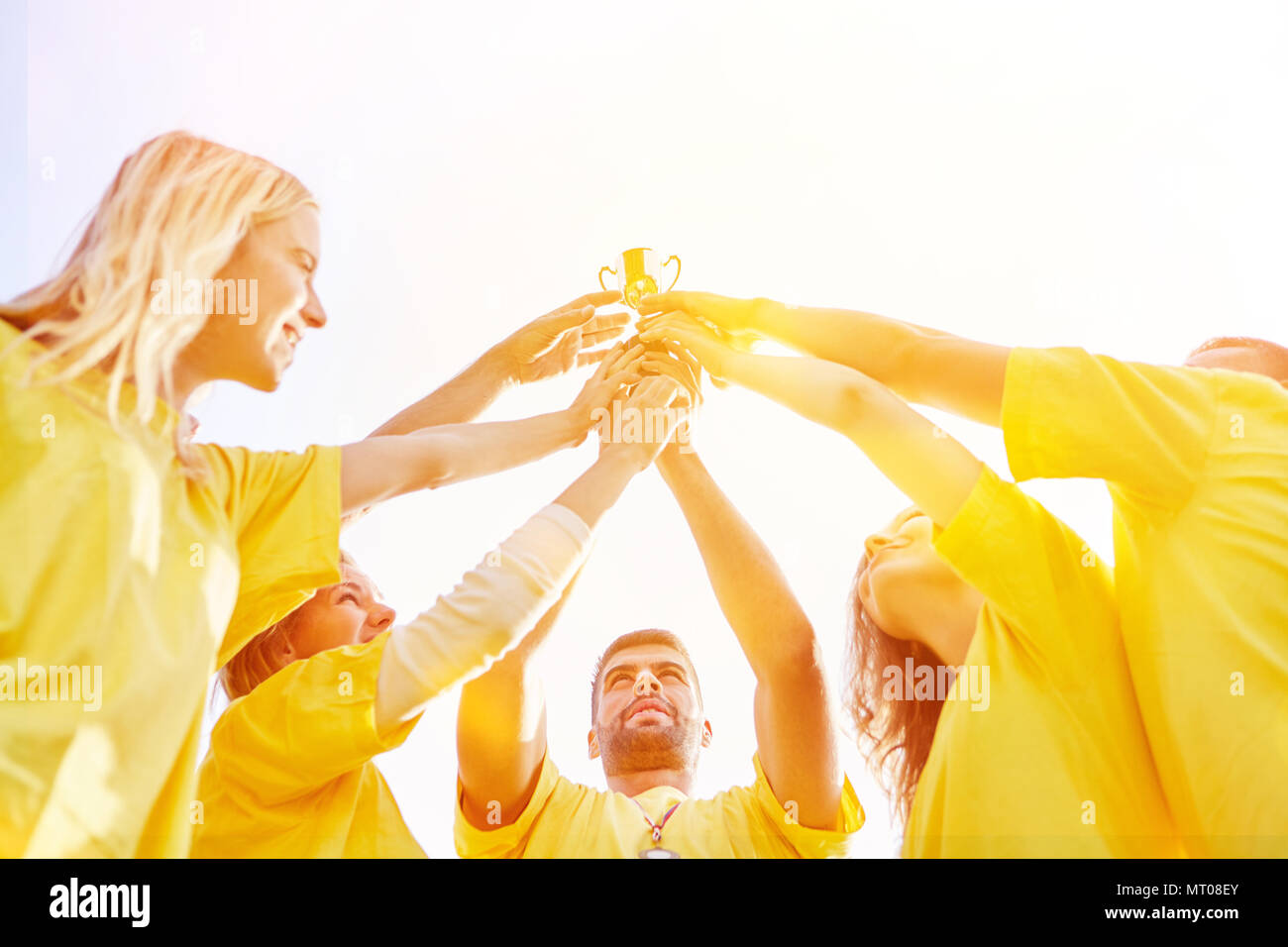 Success with trophy in team or team in sport Stock Photo - Alamy