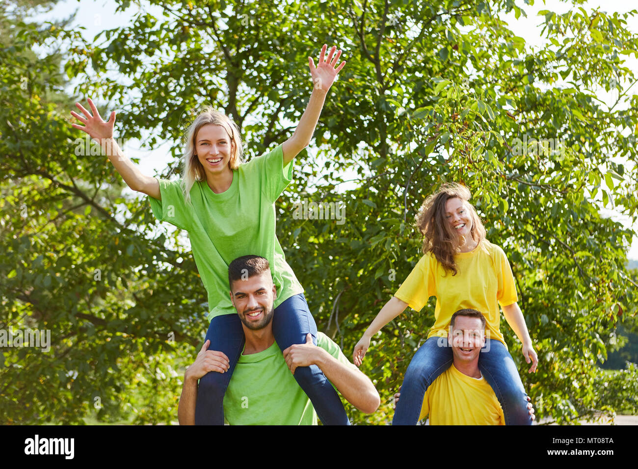 Young people piggyback riding as an exercise on a teambuilding event ...