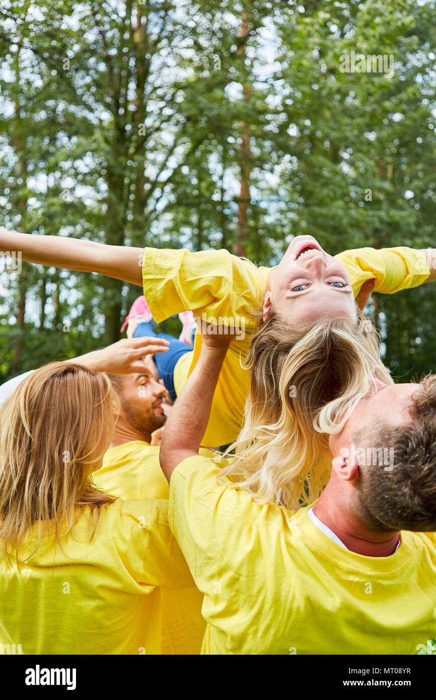 Team in the team building workshop trains confidence and makes woman ...