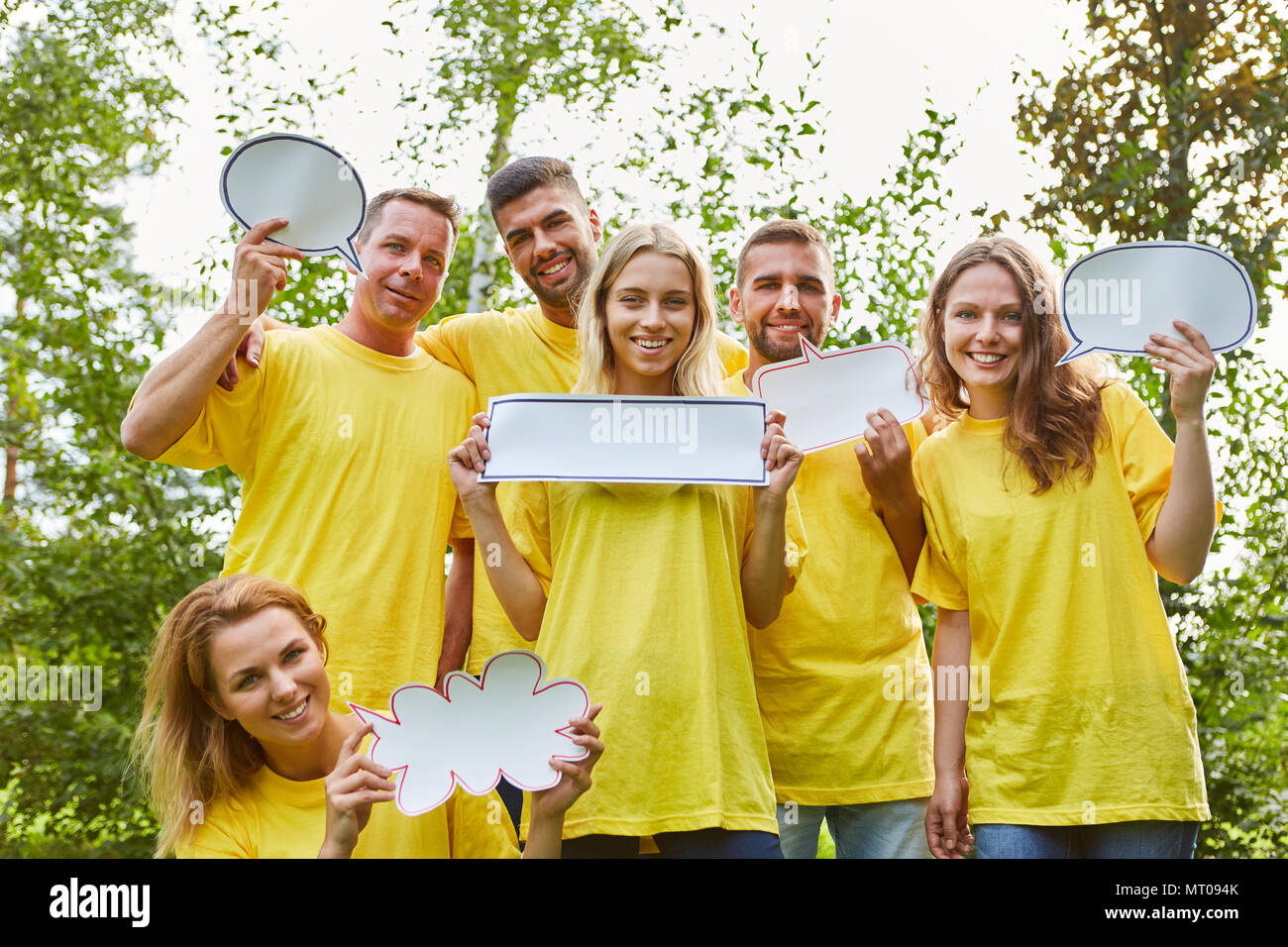 Creative young startup team showing speech bubbles as a brainstorming ...