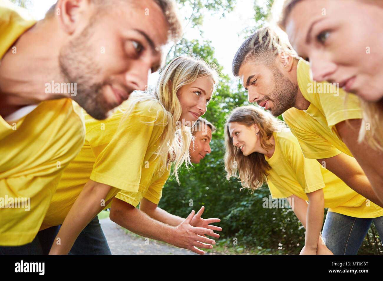 Young people are doing an exercise for teamwork at the teambuilding ...