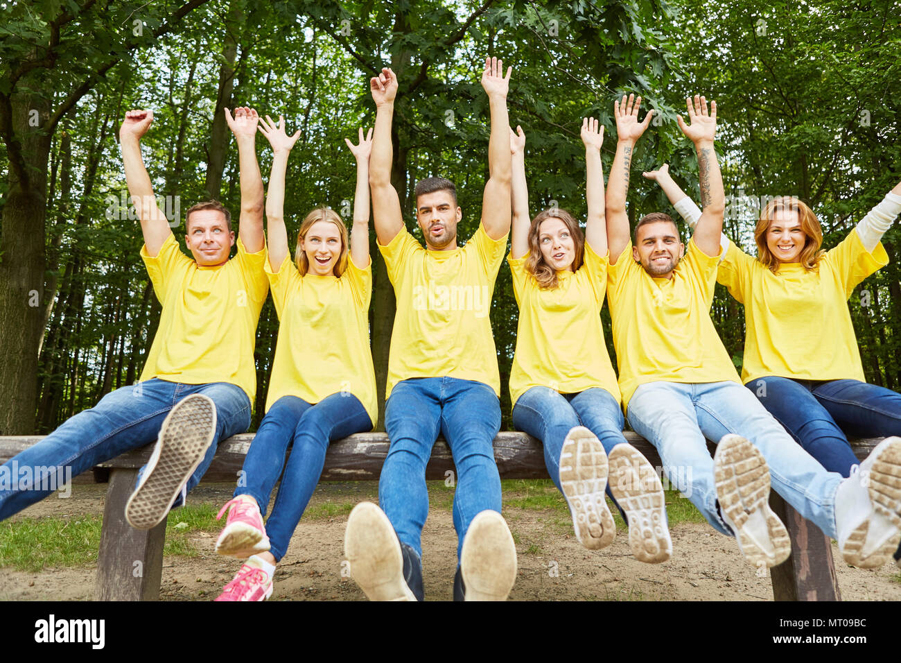 Young people as a successful team cheer at a team building event Stock ...