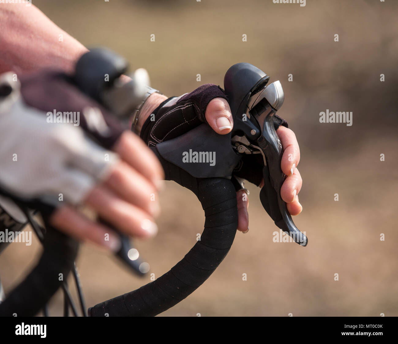 Young woman's hands on the brakes of a road bike Stock Photo - Alamy