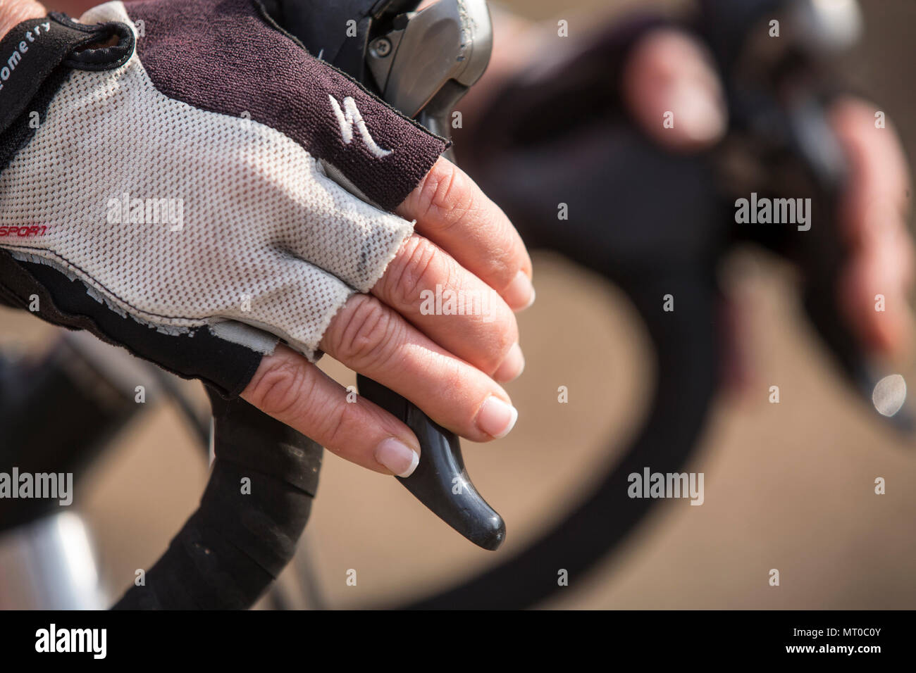Young woman's hands on the brakes of a road bike Stock Photo - Alamy