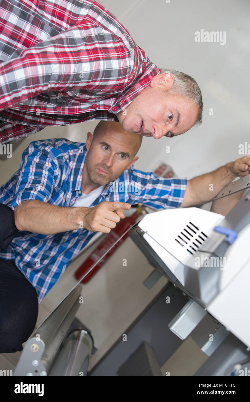 men working with industrial printer Stock Photo - Alamy