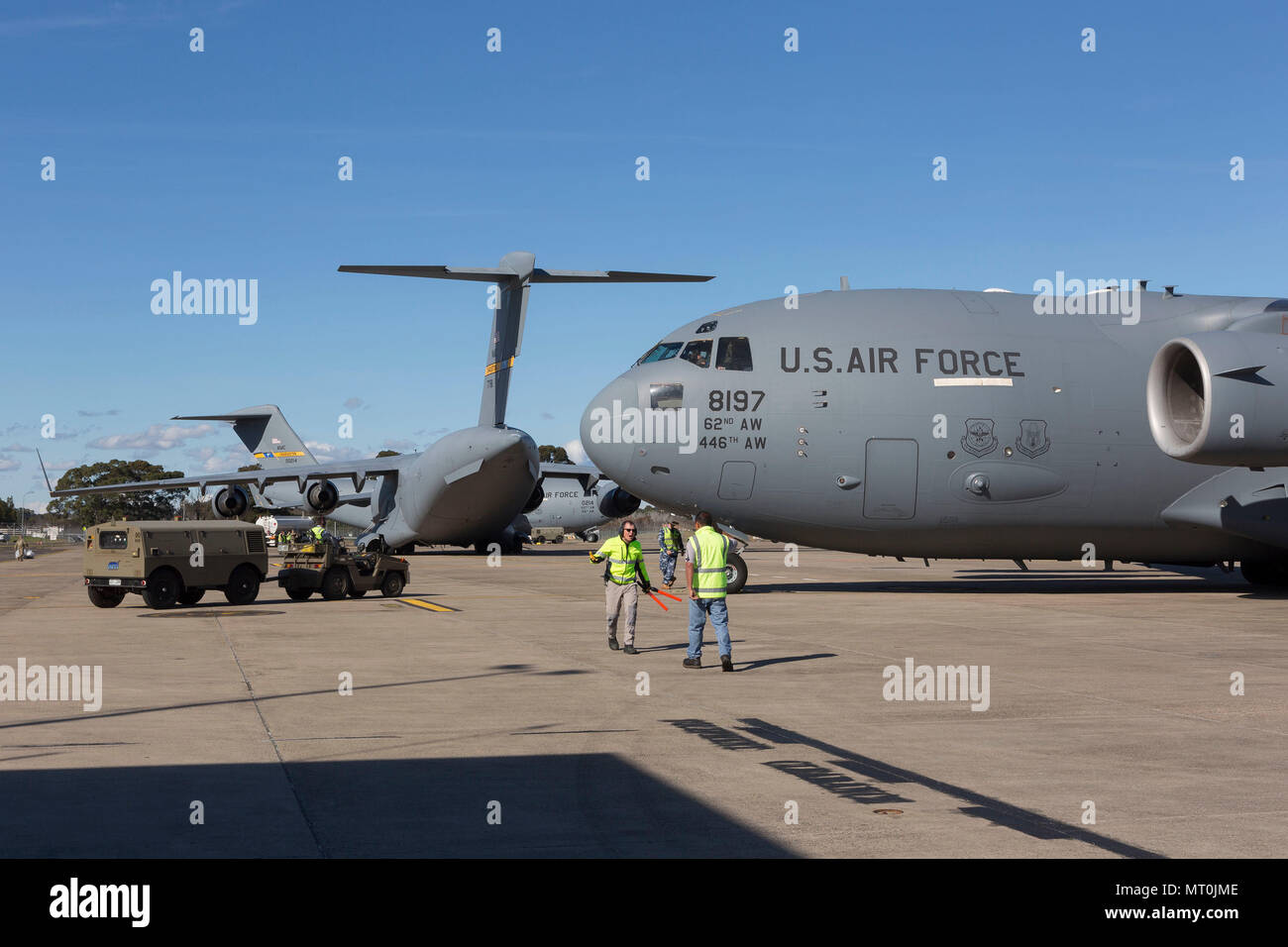 Ground personnel prepare to park the next arriving C-17A Globemaster ...