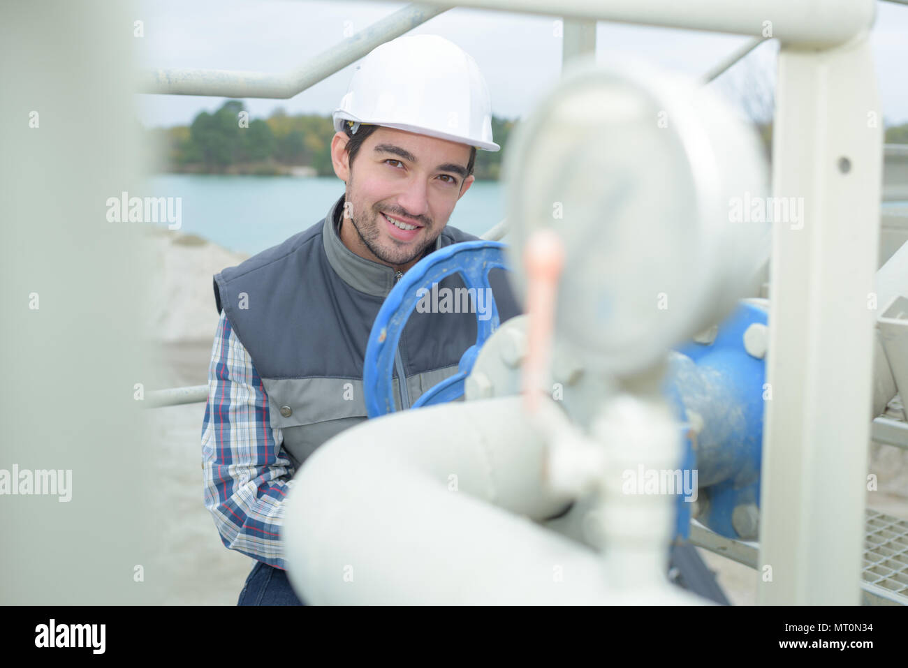 working man in a helmet oustide a factory Stock Photo - Alamy