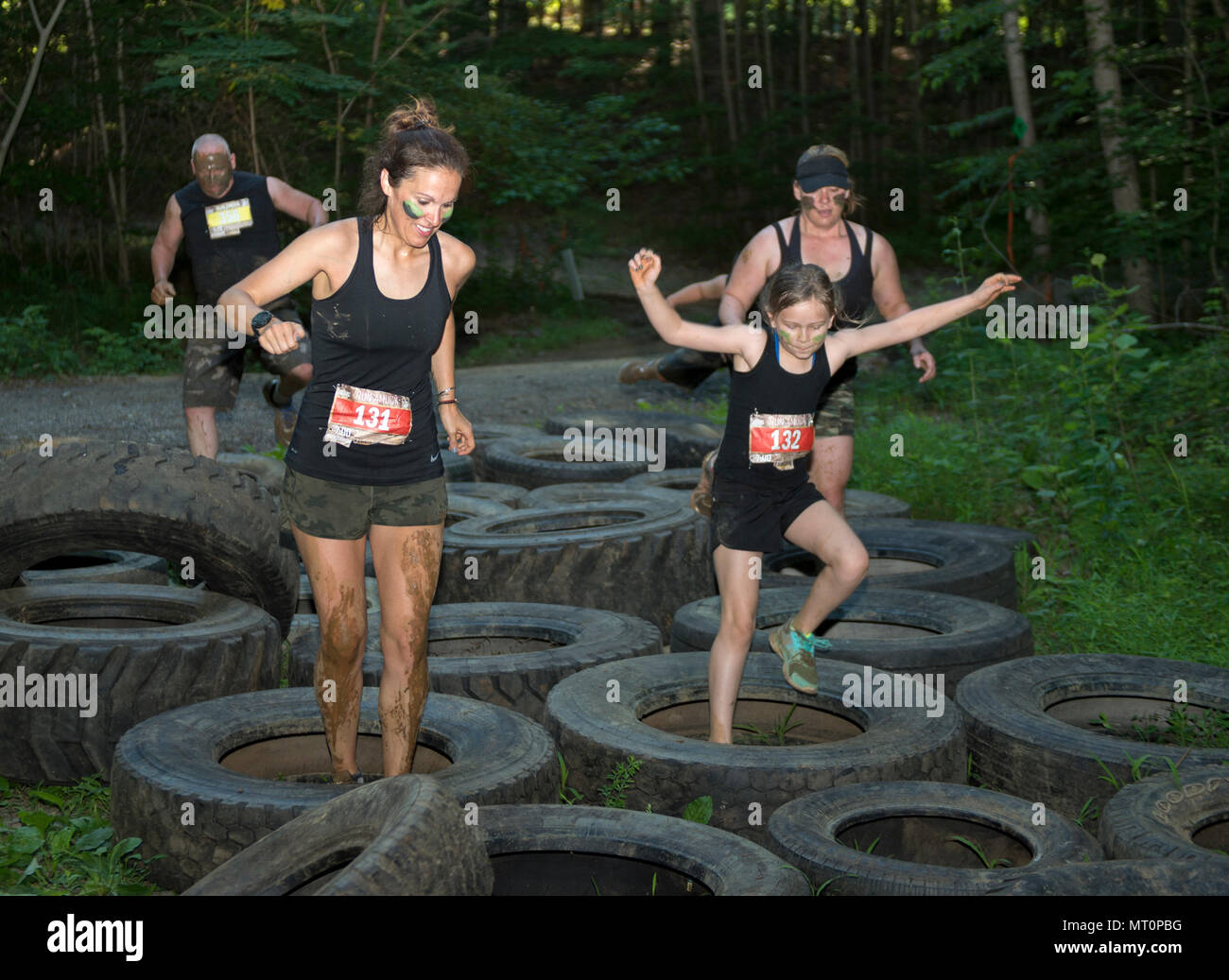 Participants maneuver through an obstacle during the annual Marine ...
