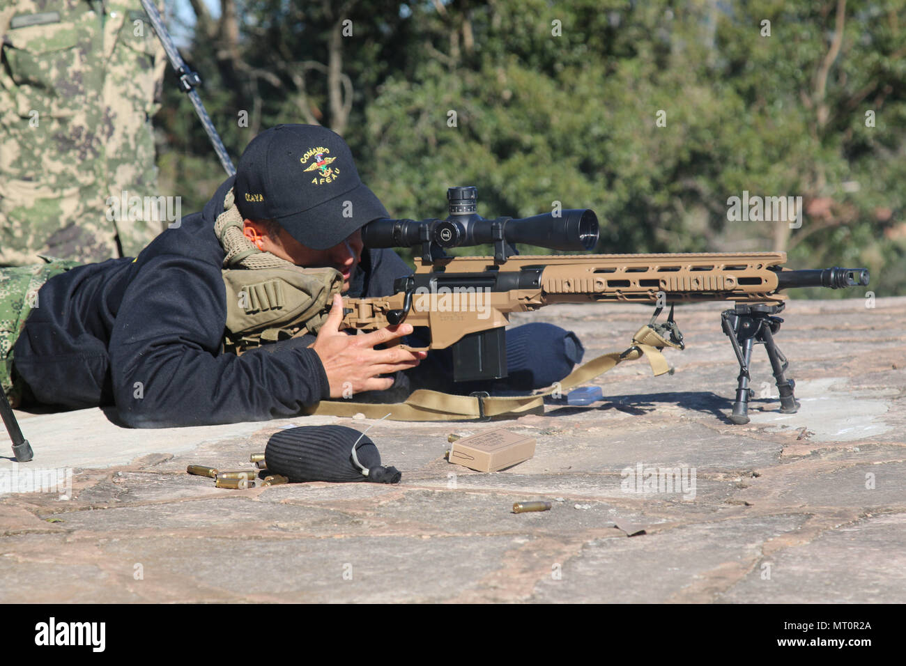 A Colombian competitor zeros in on his target at the field sniper event ...