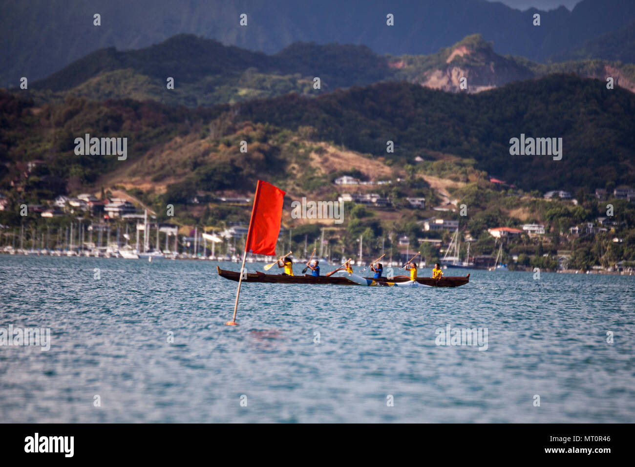 A canoe team paddles towards the starting line of the “Na Koa Lani ...