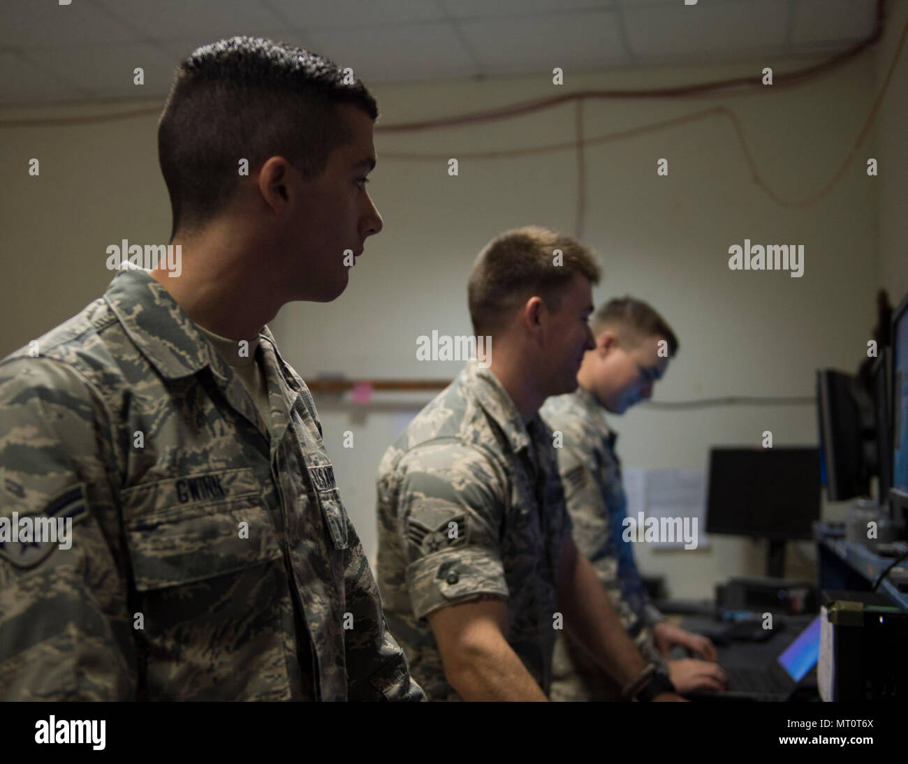 U.S. Air Force Airman 1st Class Robert Gwinn, left, a computer service ...
