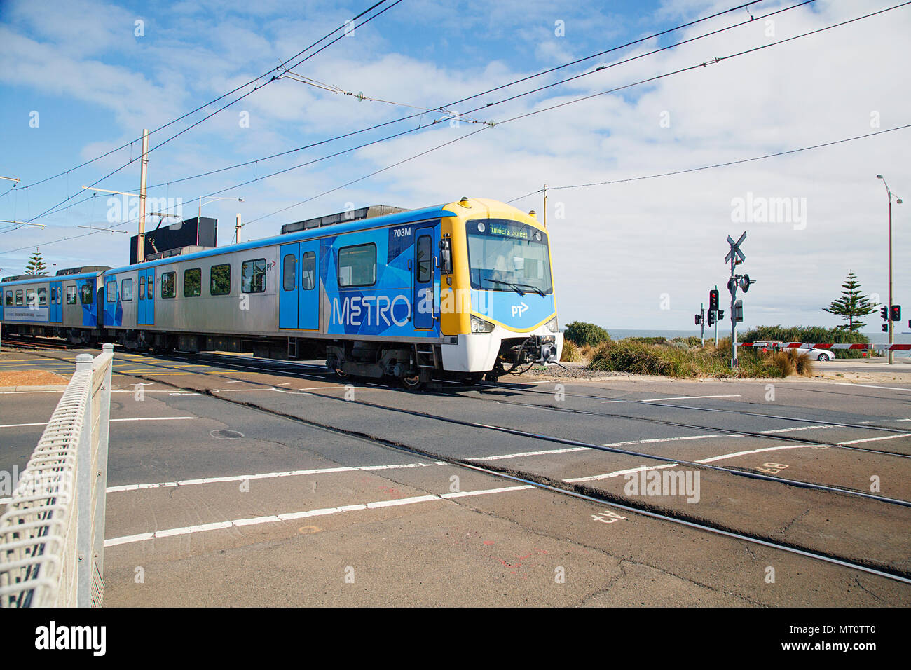 Melbourne, Australia: April 03, 2018: A train crosses a level crossing ...