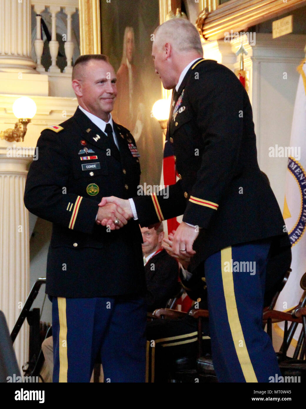 U.S. Army Col. Christopher Barron, congratulates Col. William M. Conde ...