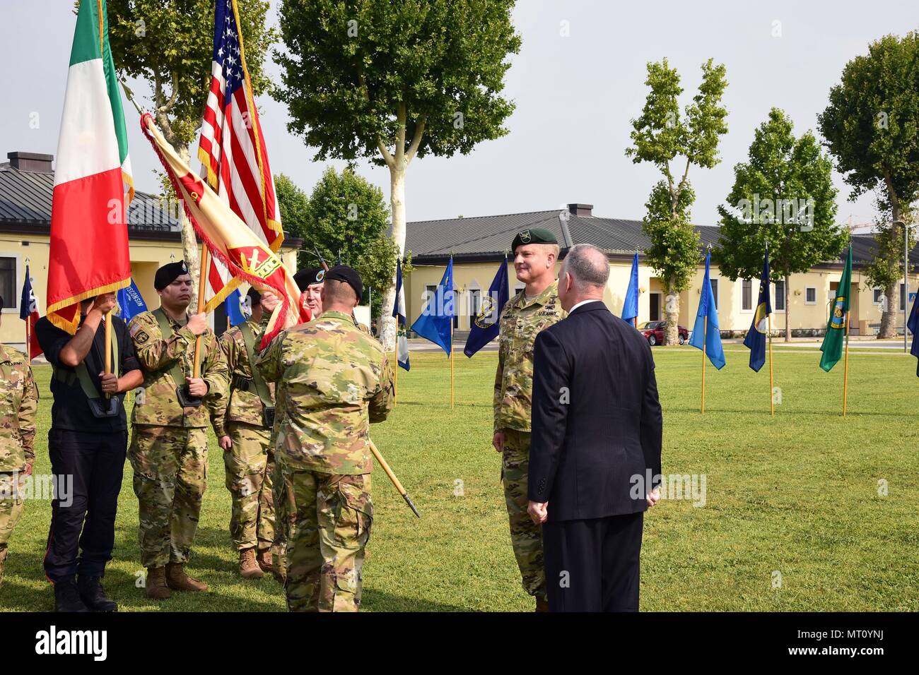 Col. Eric M. Berdy passes the colors to Command Sgt. Maj. Mason L ...