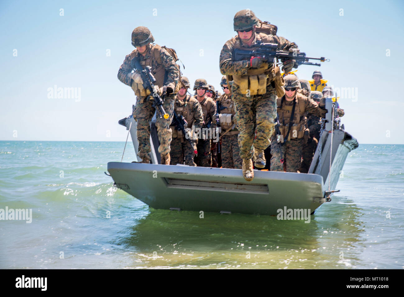 U.S. Marines with 3rd Battalion, 23rd Marine Regiment, assault a beach ...