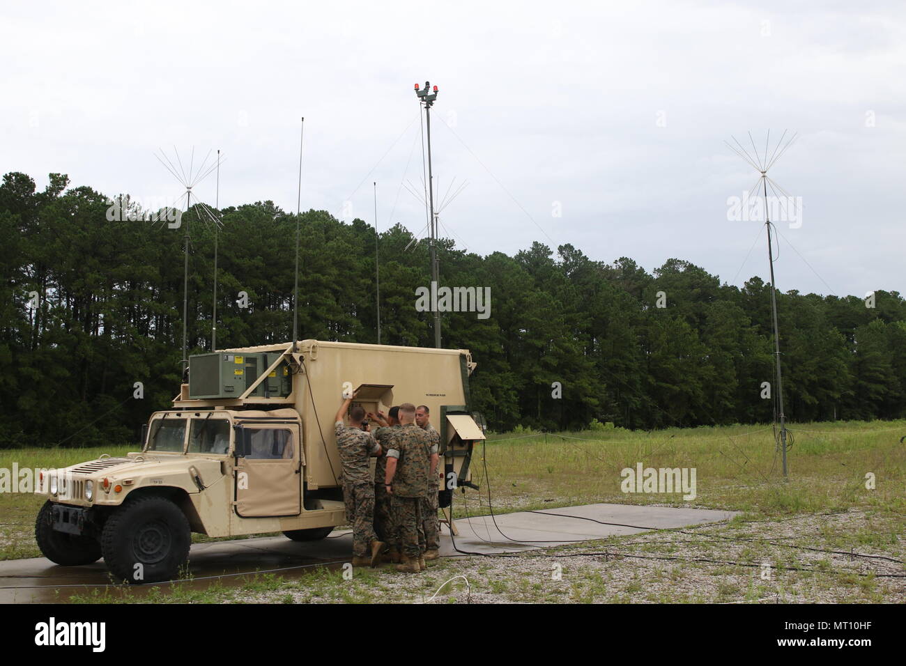 Radar technicians with Detachment Charlie, connect the operator shelter ...
