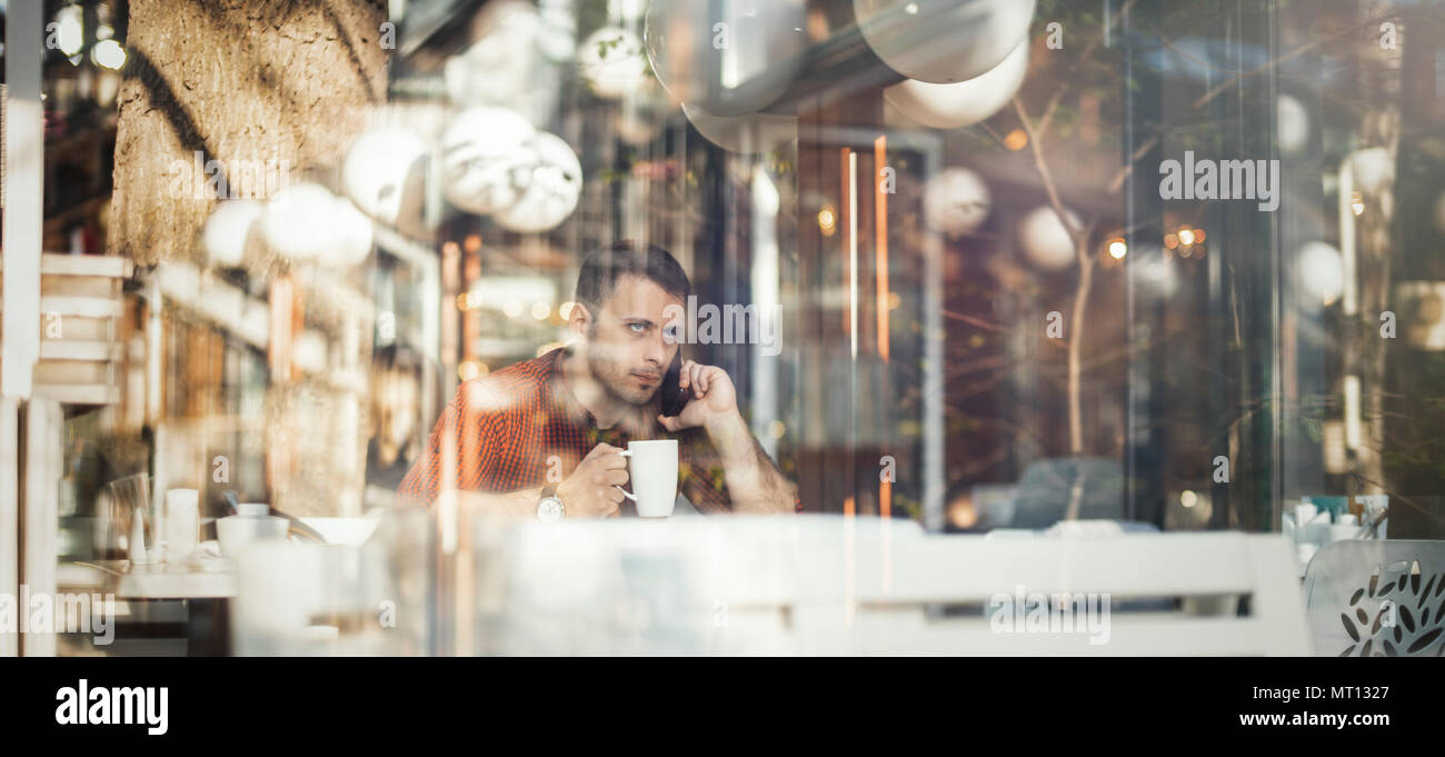Talking on phone man drinking hi-res stock photography and images - Alamy