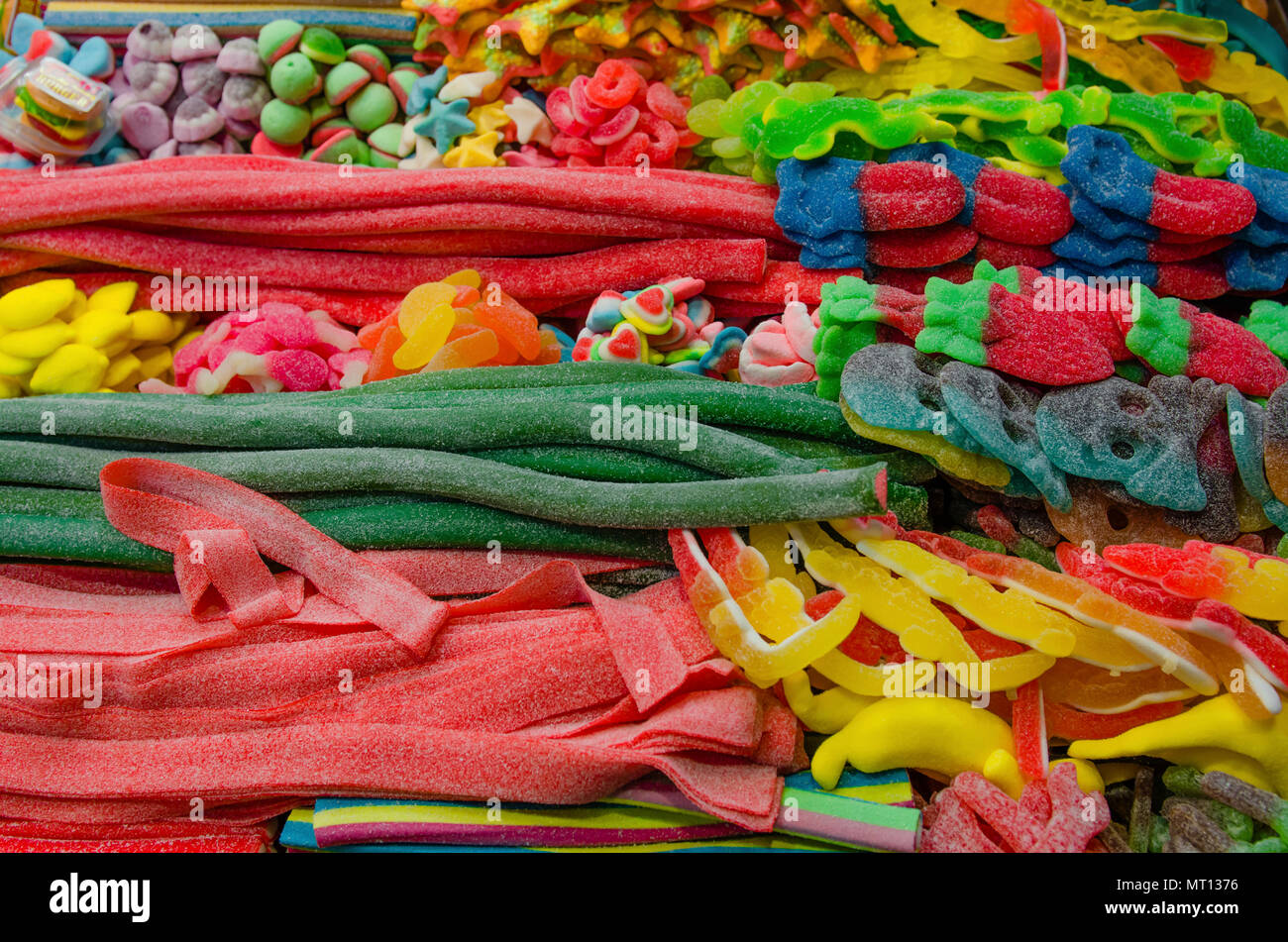 Confectionery on the market store shelves. Variety of colored sweets ...