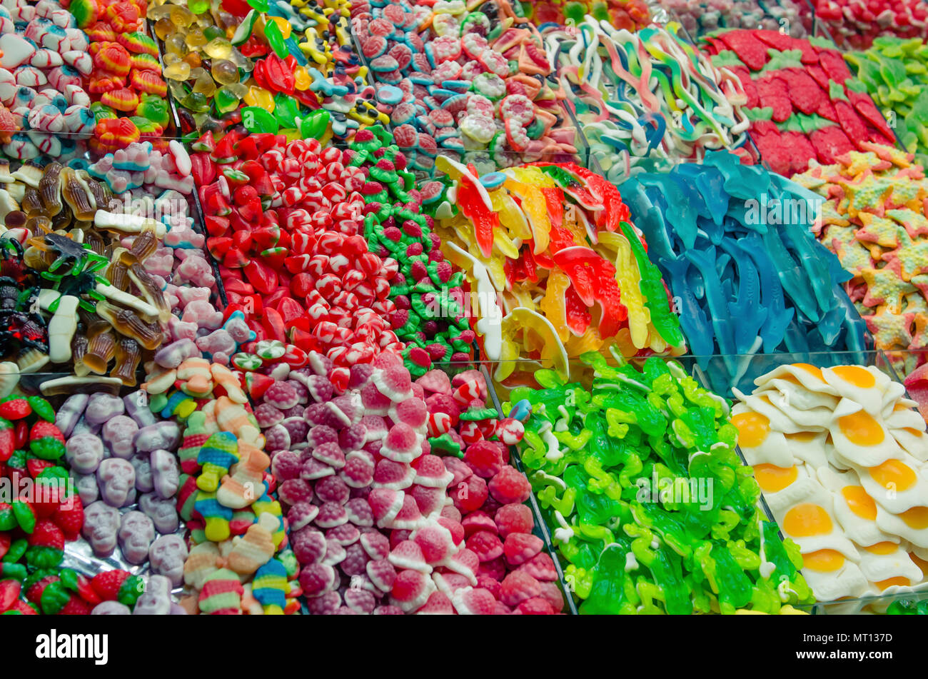 Confectionery on the market store shelves. Variety of colored sweets ...