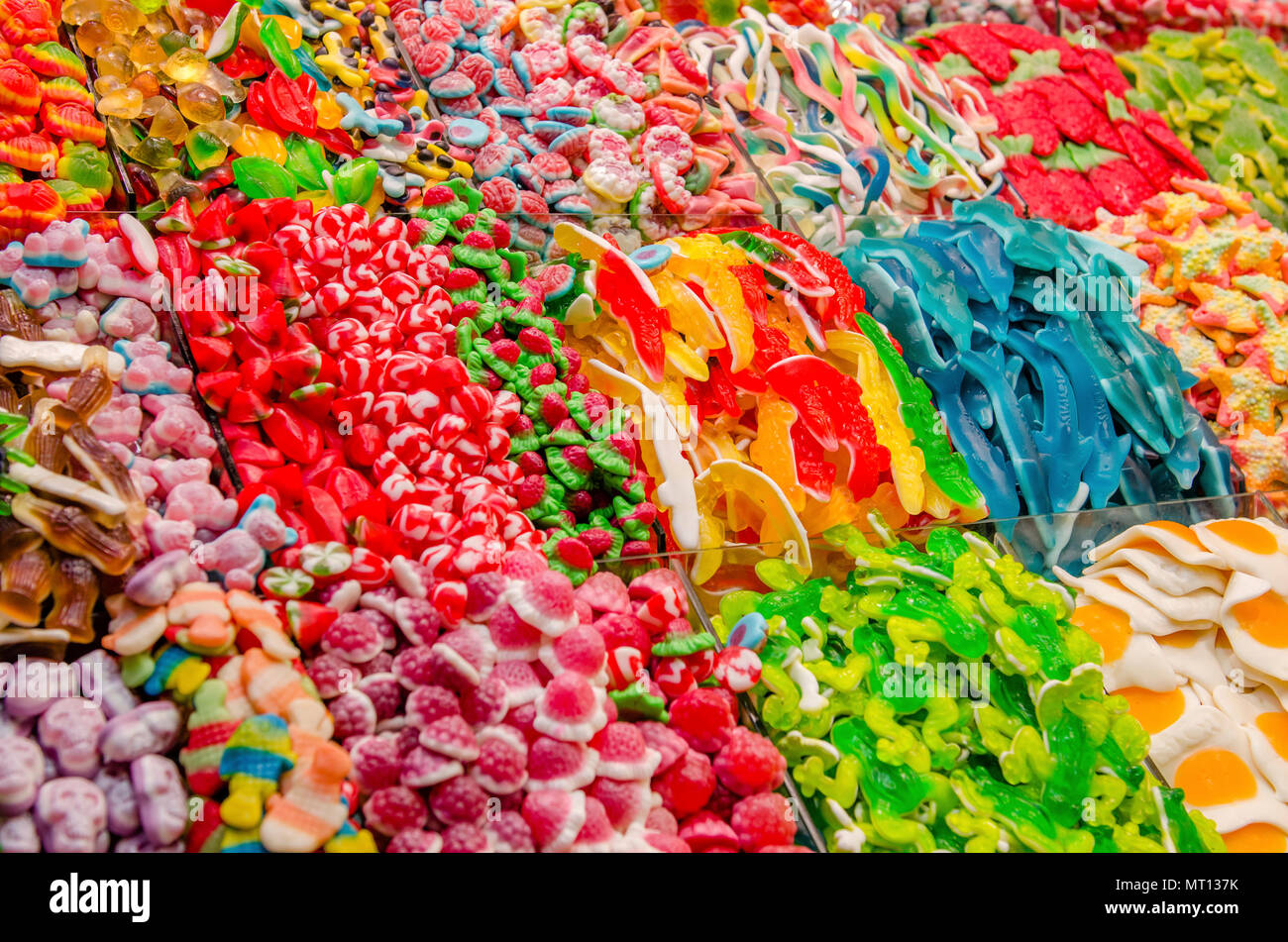 Confectionery on the market store shelves. Variety of colored sweets ...