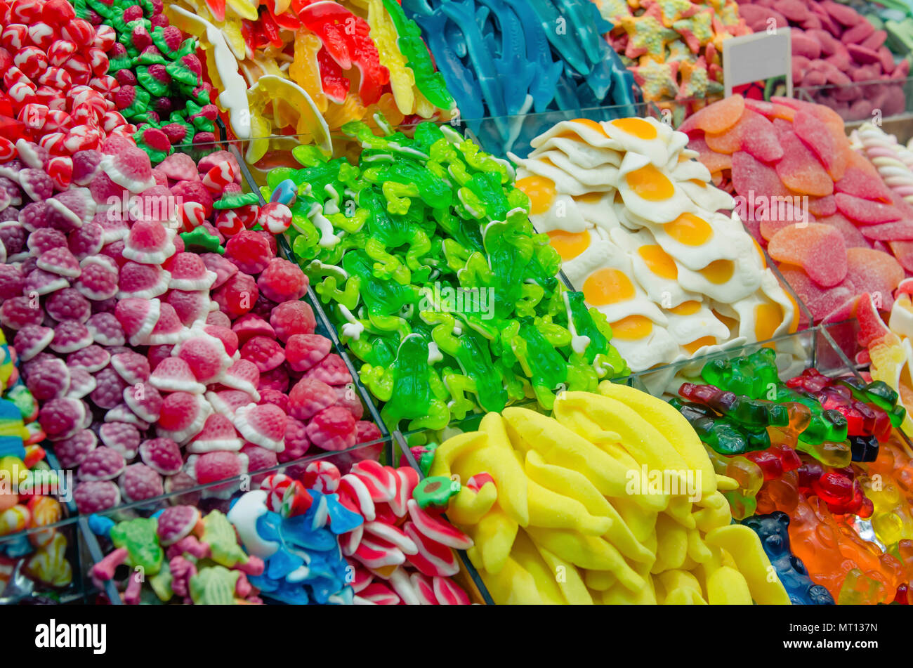 Confectionery on the market store shelves. Variety of colored sweets ...