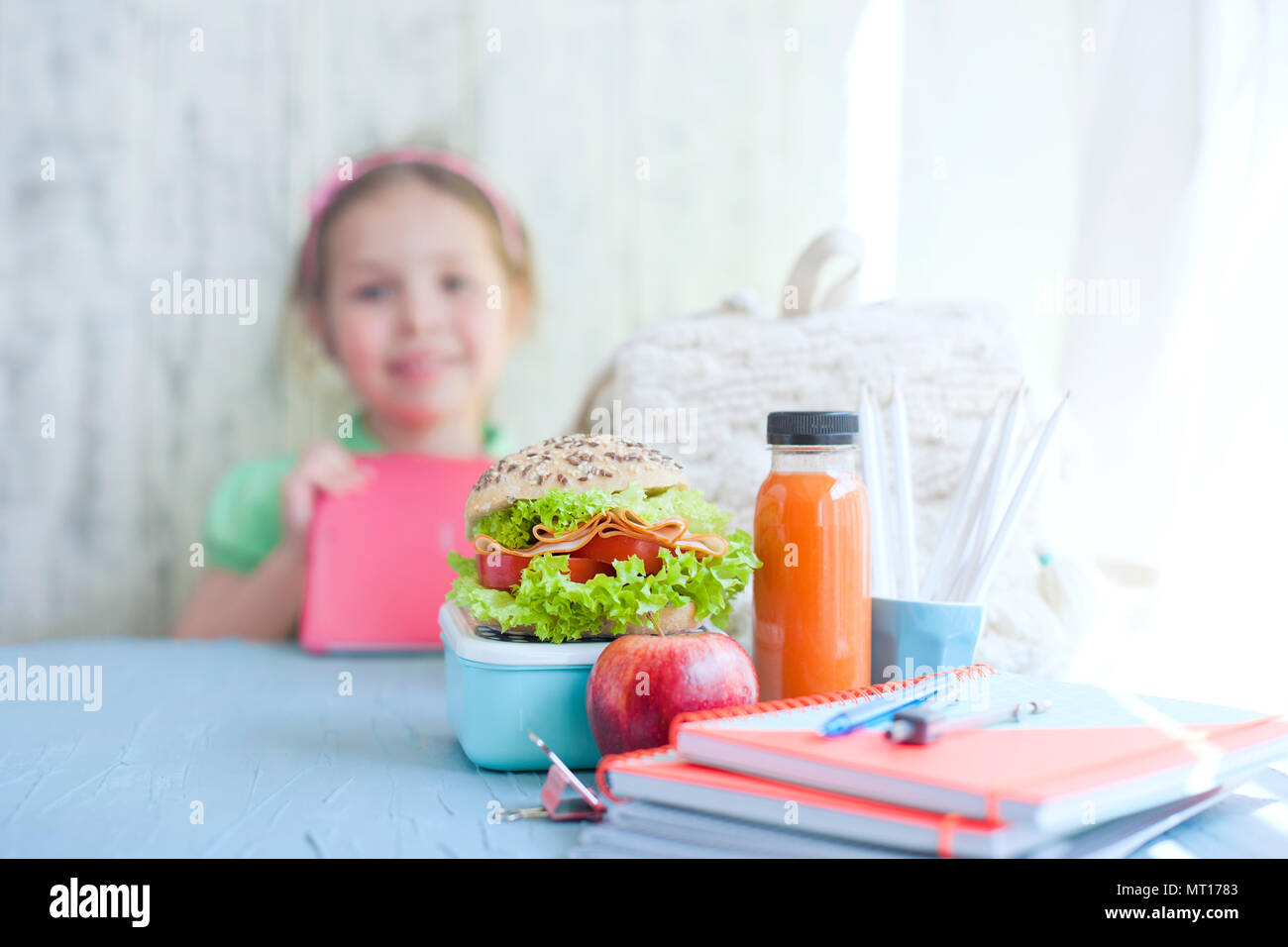 Portrait schoolgirl looking at camera while having lunch during Stock ...