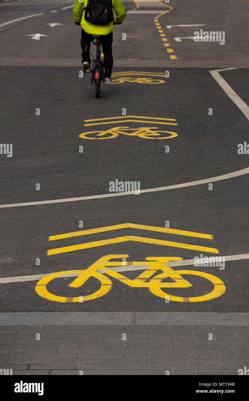 Yellow sign of a bicycle path drawn on the asphalt road. Lanes for ...