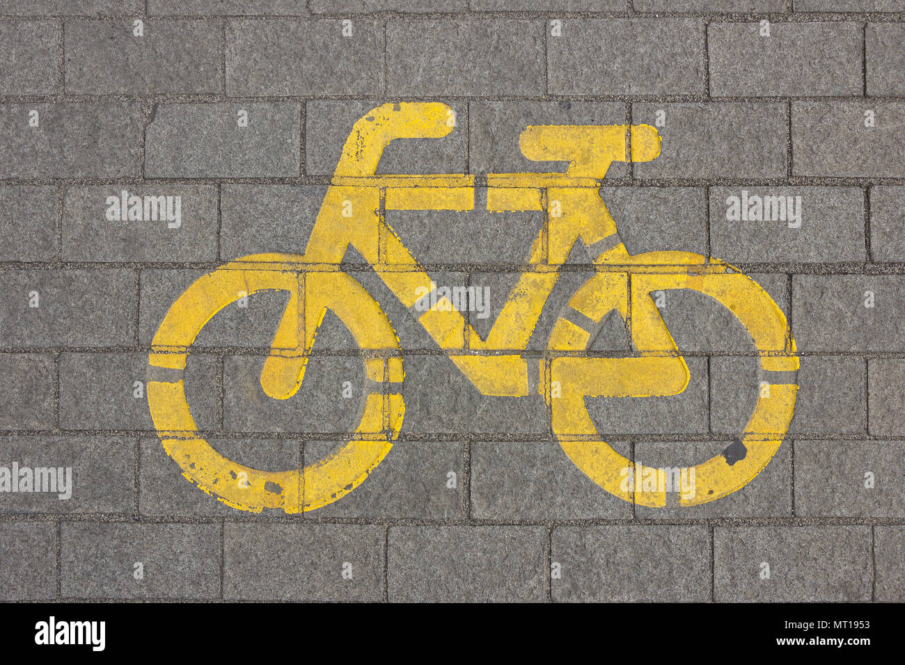 Yellow sign of a bicycle path drawn on the asphalt road. Lanes for ...