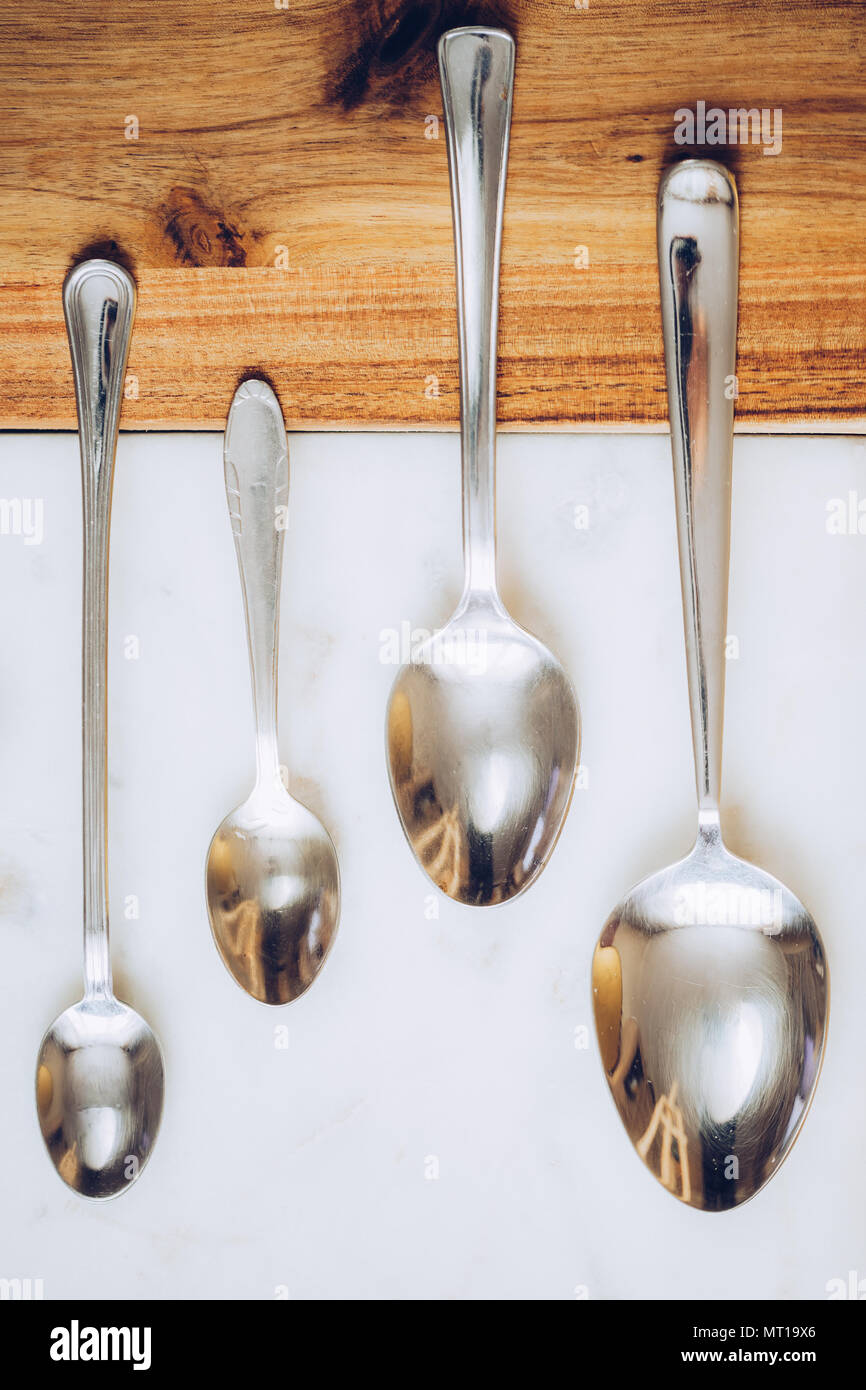 different spoons on stone marble wooden table background. Rustic ...