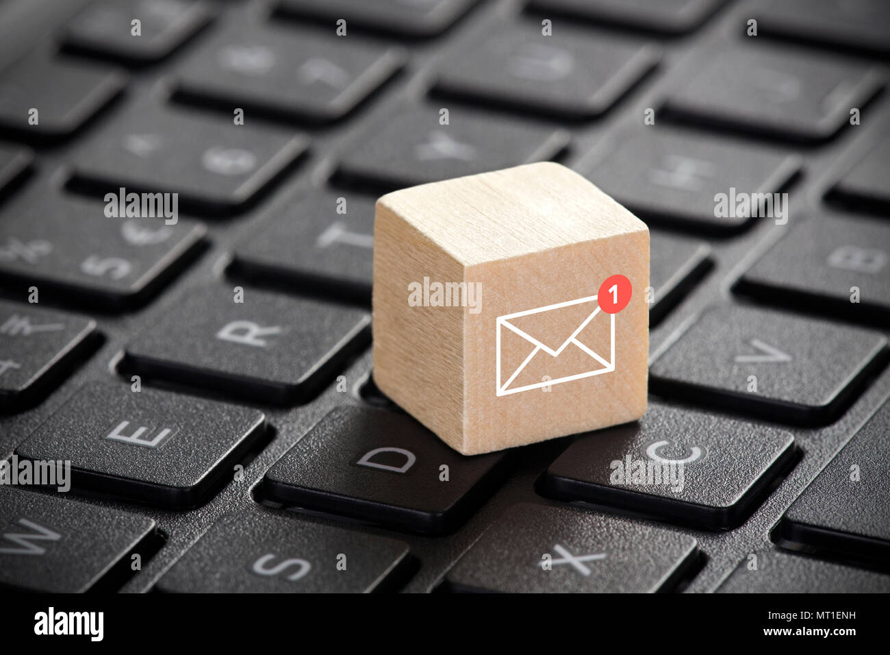 New email graphic on wooden block over laptop keyboard Stock Photo - Alamy